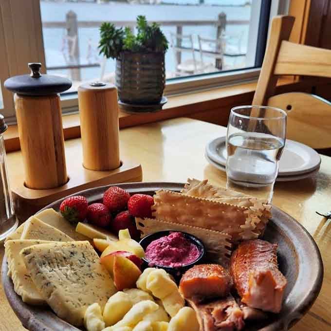Smoked fish, artisan cheese, and fresh berries arranged like edible treasure with the harbor view as your entertainment backdrop.