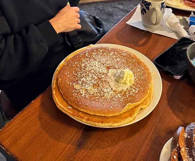 This pancake is roughly the size of a hubcap and looks twice as delicious, dusted with powdered sugar perfection.