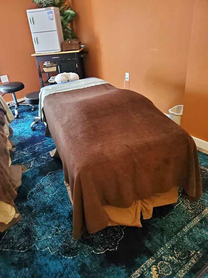 Your massage table awaits in this cozy treatment room where stress goes to retire permanently.