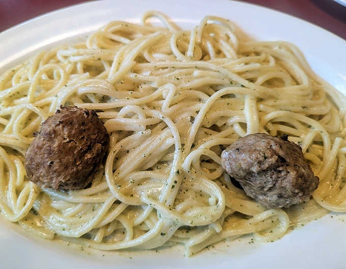 Spaghetti with meatballs so perfectly round they look like they were sculpted by Italian artists with very specific standards.