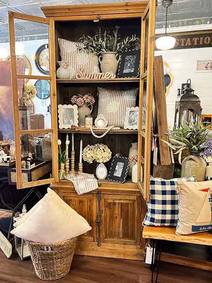 Wooden cabinets filled with vintage charm, proving storage can be stunning and functional simultaneously.