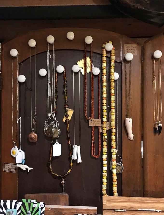 Necklaces and beads dangle like jewelry from another dimension, mixing bones, teeth, and natural elements into wearable art.