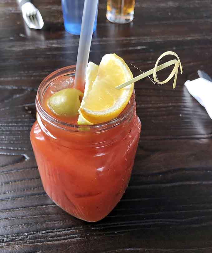 A Bloody Mary garnished to perfection, ready to complement your seafood feast with just the right amount of kick and zest.