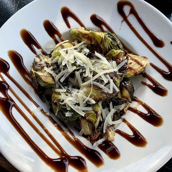Brussels sprouts drizzled with balsamic and topped with parmesan, making vegetables the unexpected star of the show.