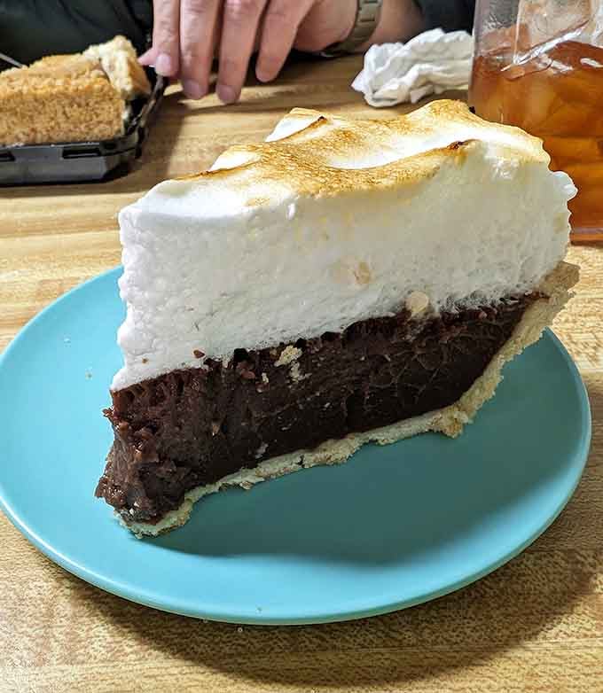 That towering slice of chocolate meringue pie could make a grown person weep tears of joy and regret simultaneously.