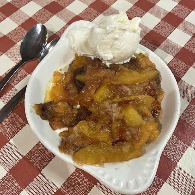 Peach cobbler topped with vanilla ice cream is the sweet ending every barbecue meal deserves and demands.
