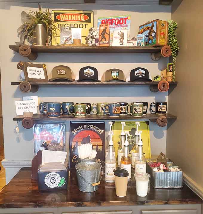 Vintage Bigfoot memorabilia and handmade mugs line rustic shelves like a cryptozoologist's treasure trove.