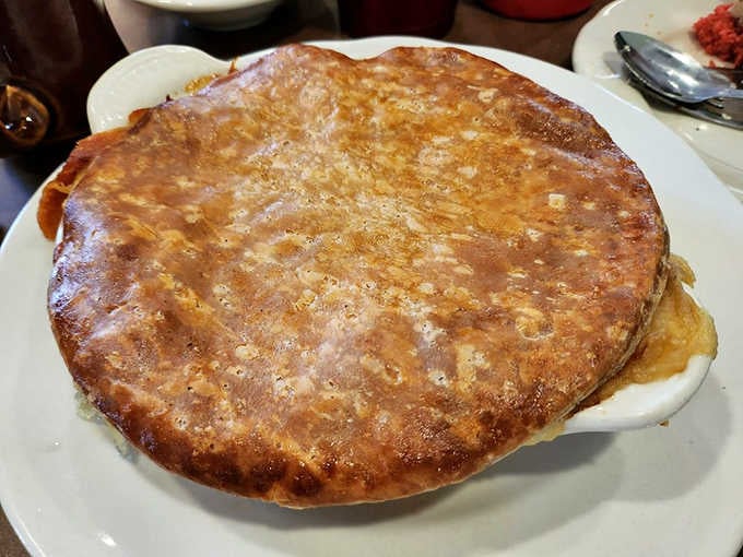 When your chicken pot pie arrives looking like a golden dome of flaky perfection, you know someone's grandmother taught them right.