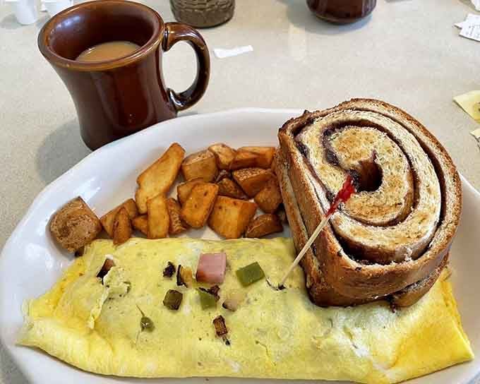 That Western omelet comes with cinnamon roll backup and home fries that understand their assignment perfectly.