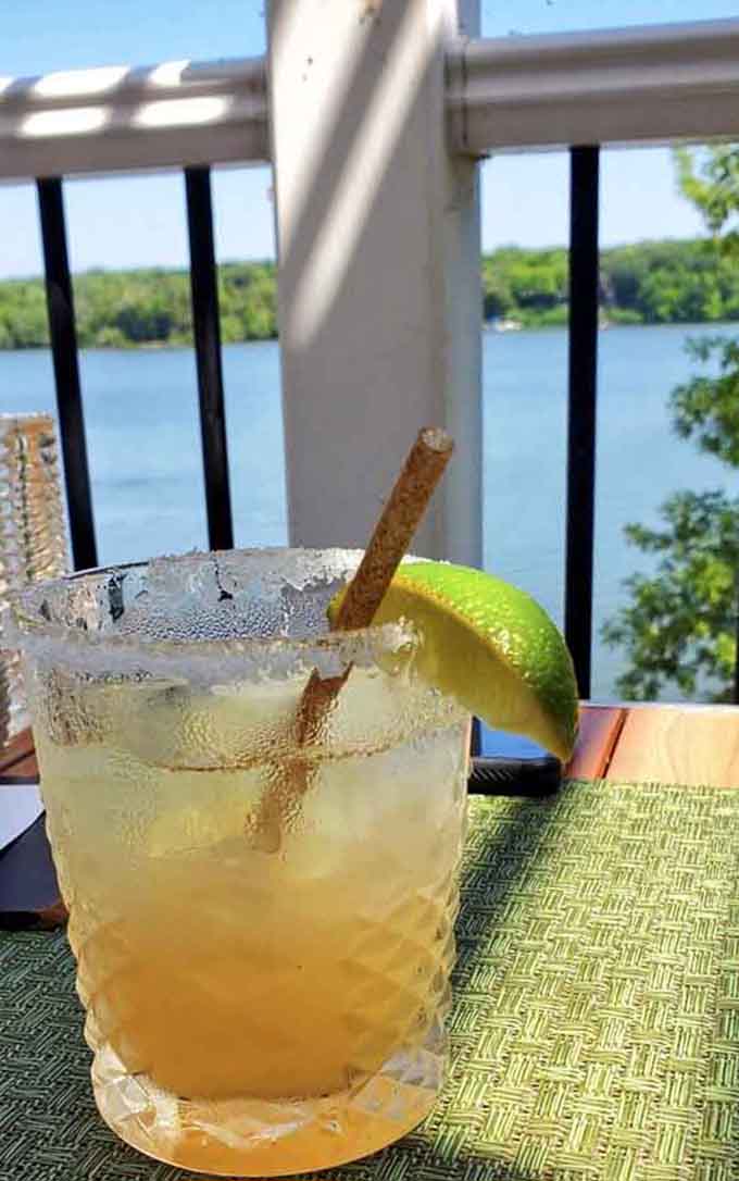 This margarita with a cinnamon stick garnish pairs perfectly with that stunning lake view behind it&mdash;vacation mode activated.