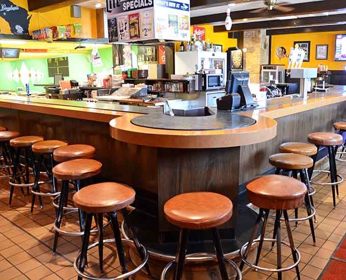 That circular bar setup encourages conversation and camaraderie, the social heart of this beloved community gathering spot.