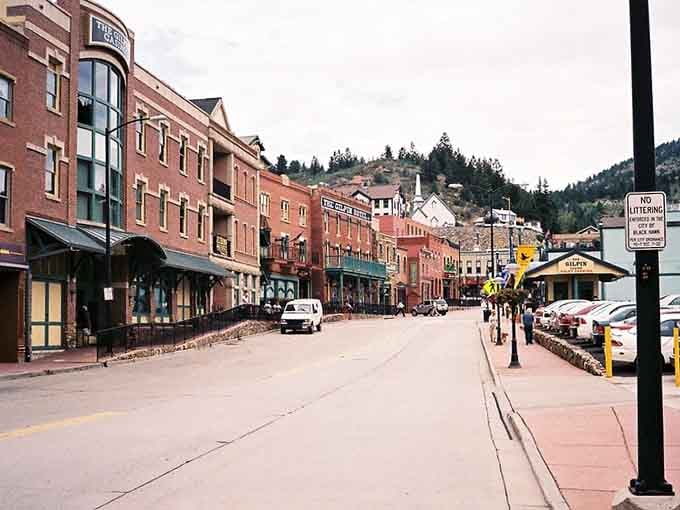 Main Street stretches through the canyon like a time traveler's fever dream, mountains watching over everything.