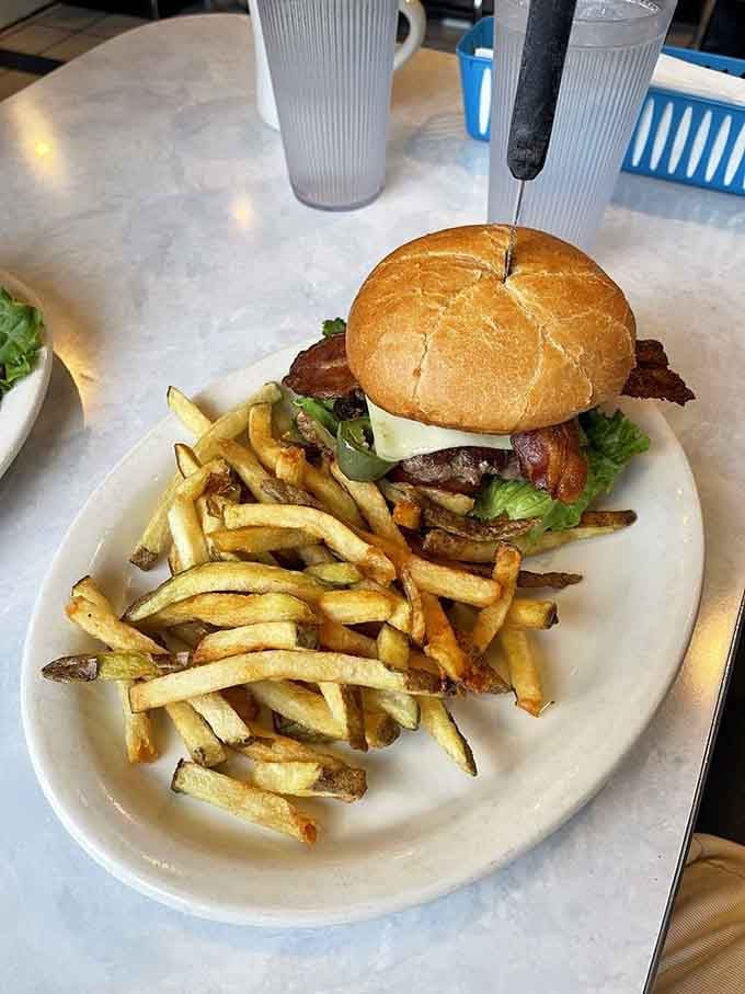 That burger needs a toothpick skewer just to hold itself together, which tells you everything about portion sizes here.