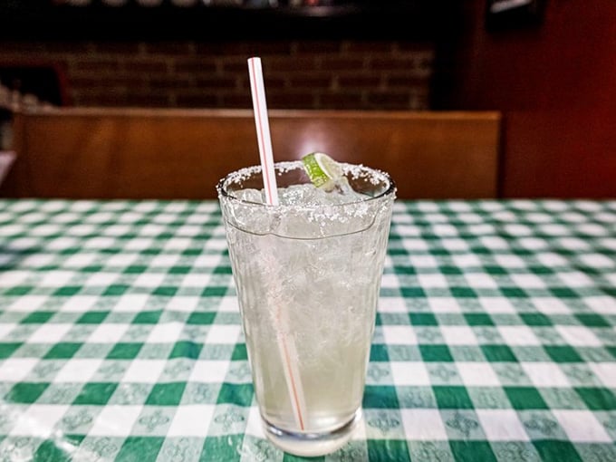 This margarita comes with a salted rim and lime, perfect for sipping while you wait for pizza perfection.