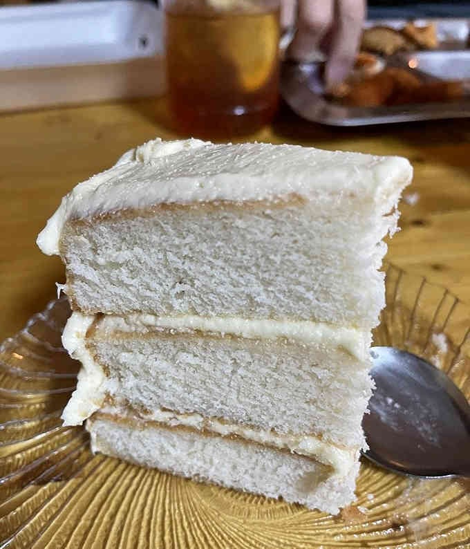 That towering amaretto cake slice stands tall and proud, ready to provide the sweet finale your meal deserves.