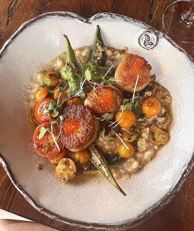 Scallops nestled in risotto with asparagus, because sometimes the ocean and the garden need to have a conversation on your plate.