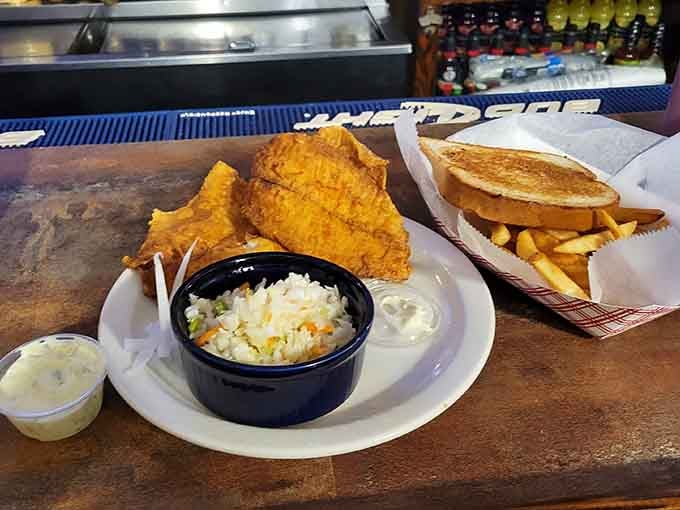 Fresh fish fried to golden perfection with coleslaw, proving this place does more than just incredible chicken dishes.