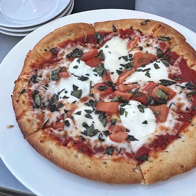 Wood-fired pizza with fresh mozzarella and basil, because sometimes Italian and Southern cooking should absolutely have a conversation.