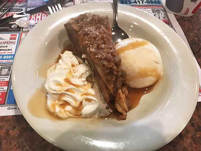 Apple pie arrives warm with ice cream, because sometimes dessert isn't optional, it's absolutely medically necessary for happiness.