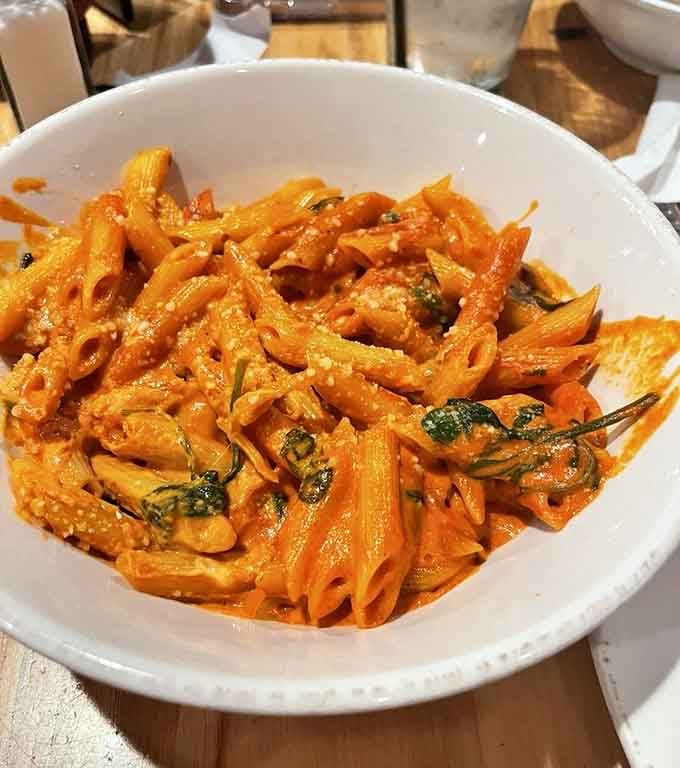 Penne vodka with spinach proving that pasta can be both indulgent and slightly virtuous simultaneously.