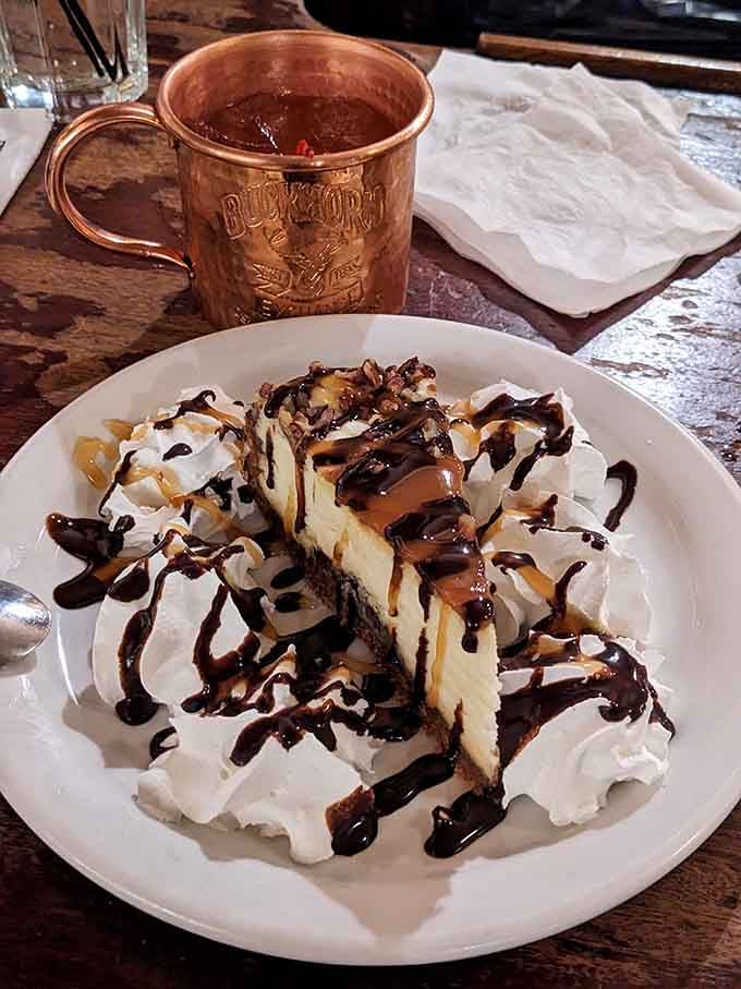 That towering slice of cheesecake with its chocolate drizzle is the sweet reward for your adventurous dining courage tonight.