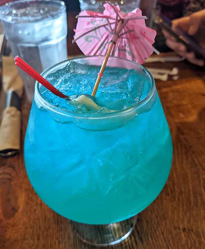 That electric blue cocktail with its tiny umbrella screams vacation mode, even if you're just twenty minutes from home.