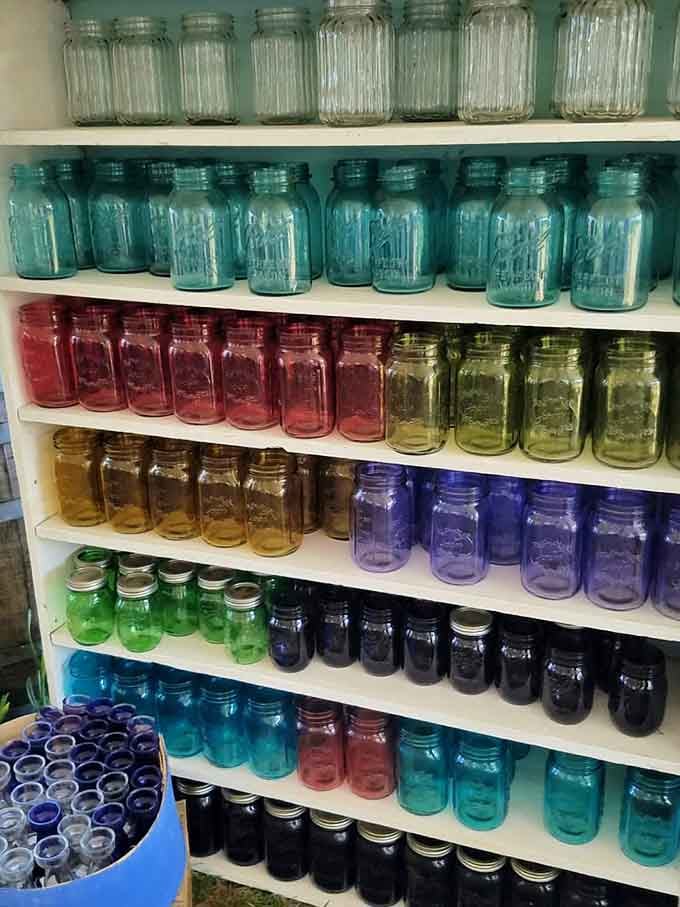 The farm store's rainbow of mason jars organized by color proves that even practical items deserve their moment to shine.