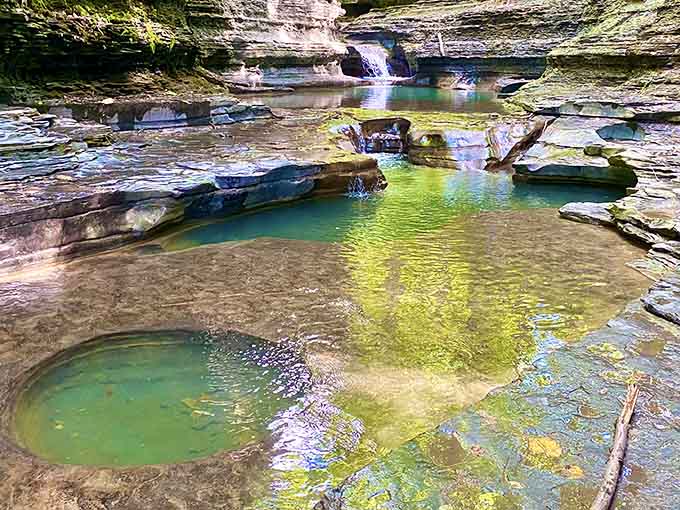 Emerald pools nestled between rock formations glow with an otherworldly light that no filter could ever replicate properly.
