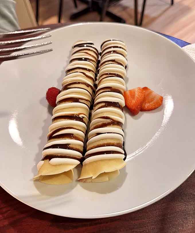 Delicate crepes drizzled with chocolate and garnished with berries: Poland's answer to French elegance, and honestly, it's winning.