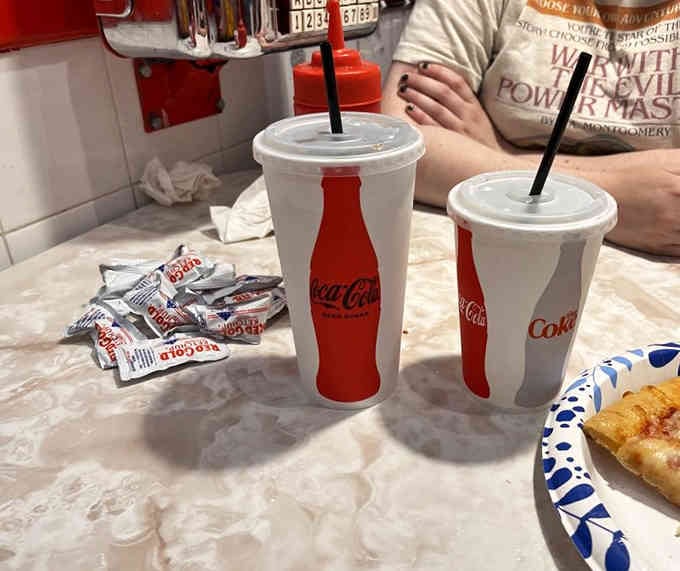 Classic Coca-Cola cups on a marble table: some combinations are too perfect to mess with, even decades later.