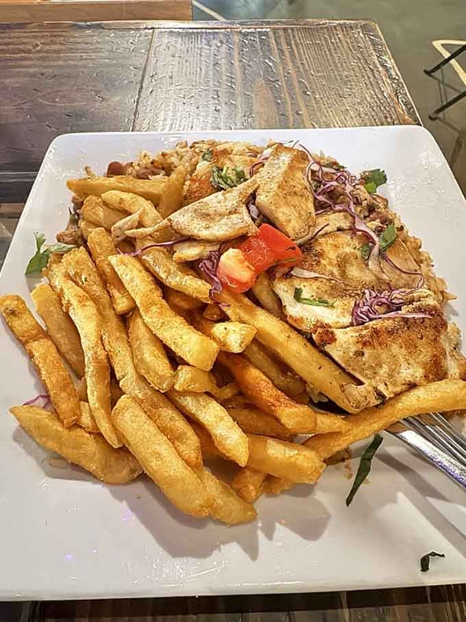 Chicken Tacu-Tacu arrives with fried eggs on top because apparently someone decided breakfast and dinner should become best friends.