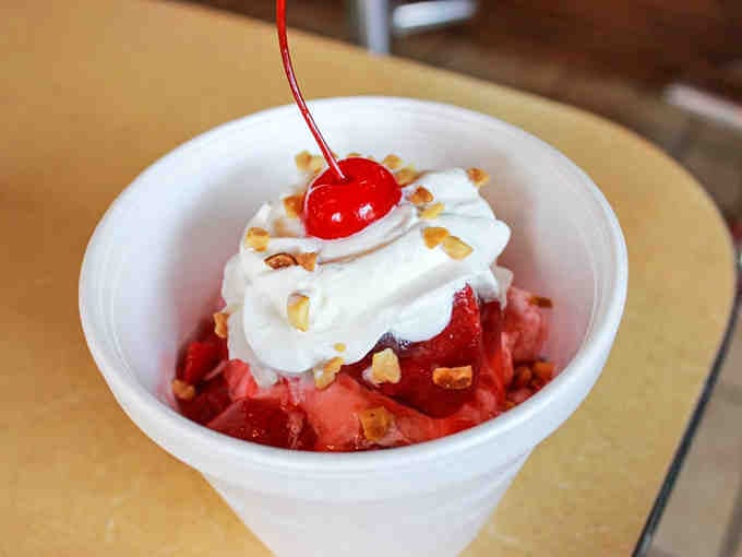 This strawberry sundae topped with whipped cream and a cherry is pure happiness served in a cup that screams summer.