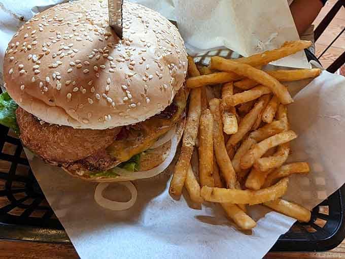 Burgers here are stacked tall enough to require an engineering degree, served with fries that understand their golden, crispy assignment perfectly.
