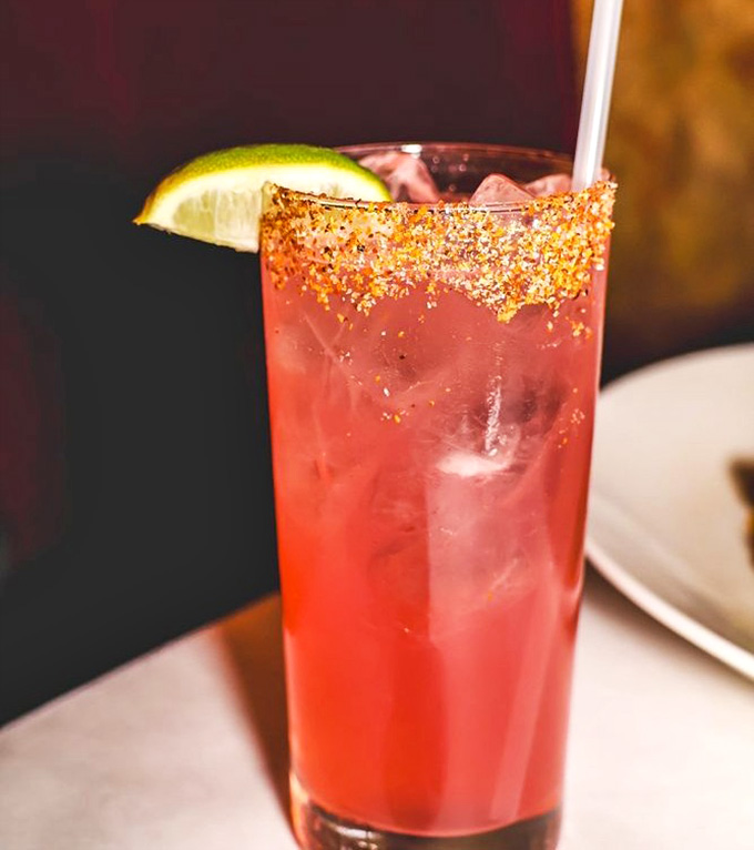 That sparkly rim and vibrant color make this cocktail look like liquid celebration decided to take physical form in a glass.