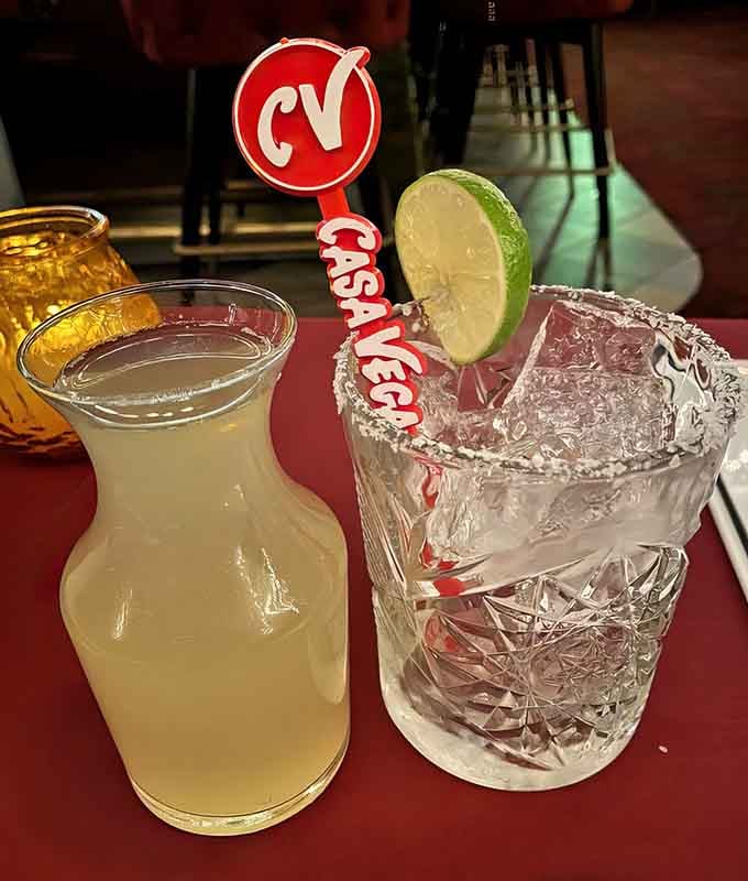 That classic margarita in its textured glass is liquid sunshine with a salt rim and serious attitude.