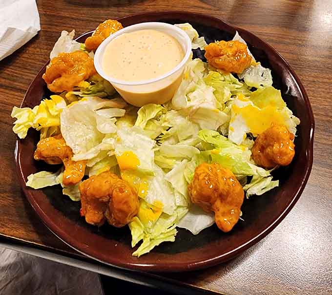 Even the salads get the royal treatment here, with golden fried shrimp perched atop fresh greens like edible crown jewels.