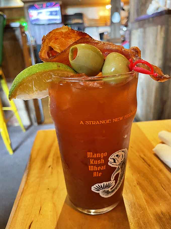 That Bloody Mary comes dressed to impress with bacon, olives, and enough garnishes to qualify as a small salad on top.
