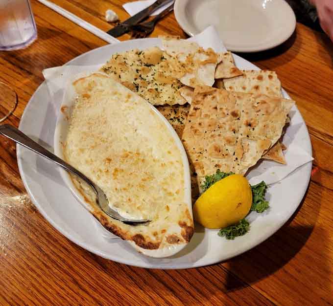 Crab dip with crackers and a lemon wedge is the kind of appetizer that makes you reconsider your entire main course strategy.