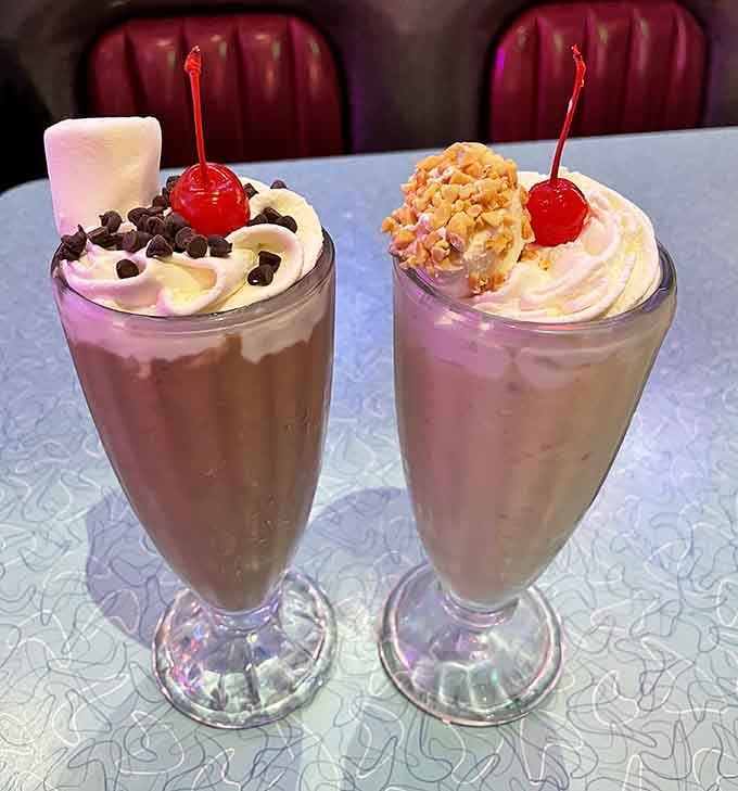 Milkshakes topped with whipped cream, cherries, and enough toppings to require engineering degrees to consume without incident or spillage.