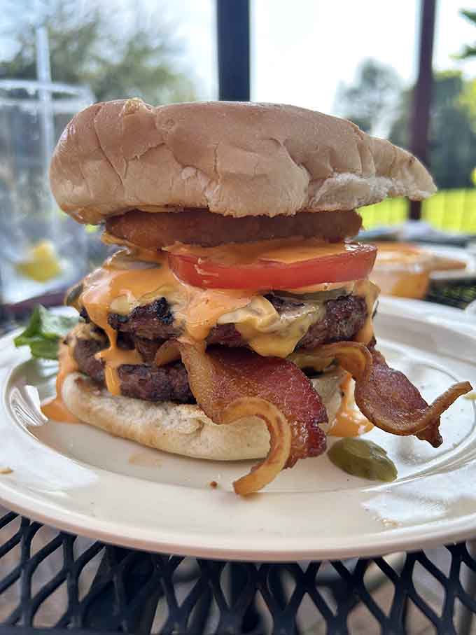 This towering burger stacked with bacon and double patties requires both hands and possibly a strategic eating plan.