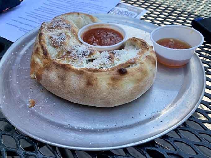 The Meathead calzone arrives dusted with parmesan like fresh snow, hiding all that meaty goodness inside.