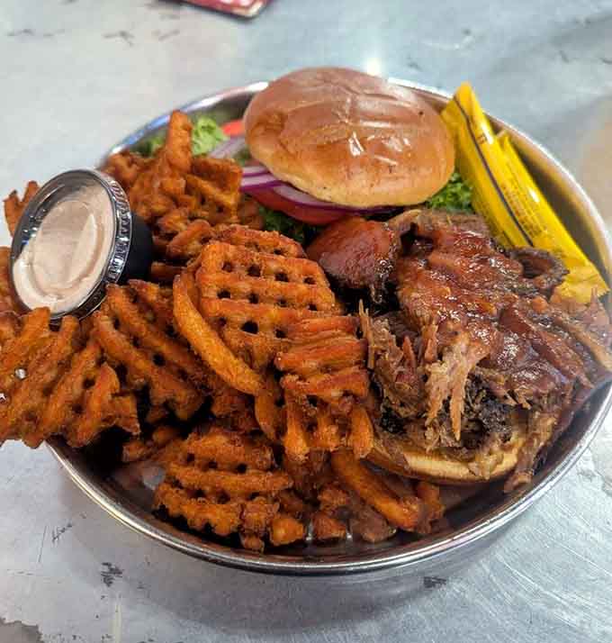 Pulled pork piled so high it's testing the structural integrity of that bun, and we're here for it.