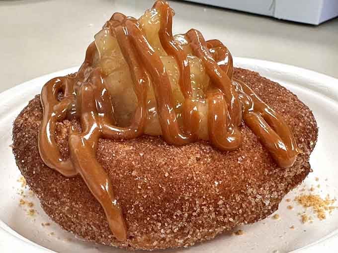 An apple pie donut drizzled with caramel that makes you wonder why anyone bothers with actual pie when this exists.