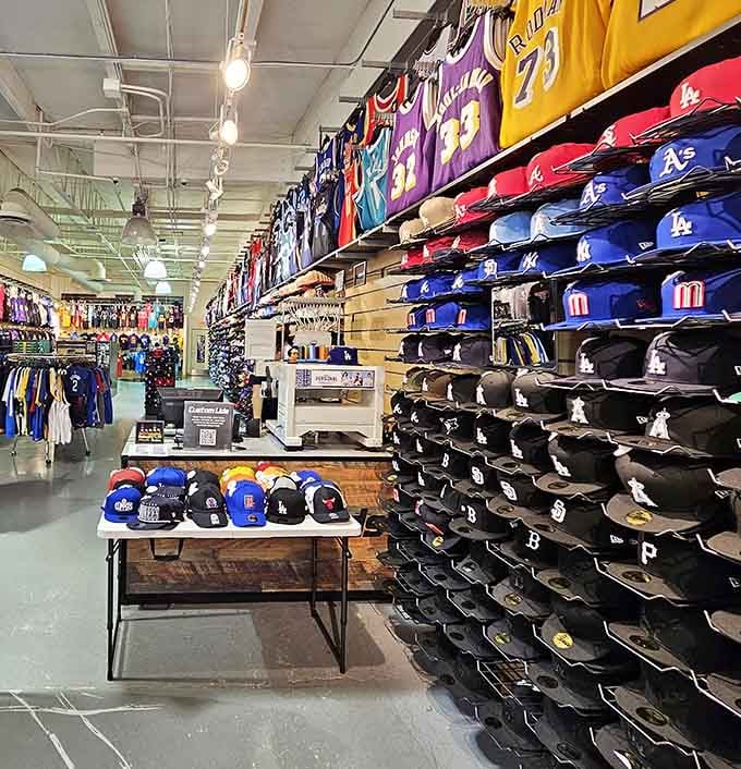 Baseball caps stacked like a sports fan's fever dream, from Lakers purple to Dodgers blue and everything in between.