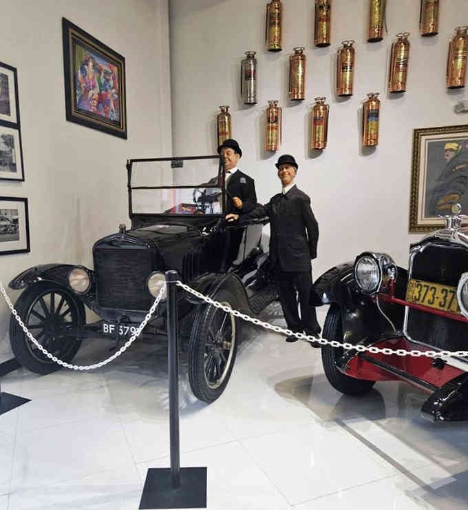 Those suited mannequins pose with a Model T like they're waiting for Gatsby to show up.