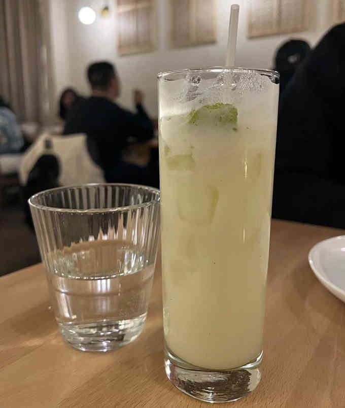 This refreshing cocktail looks like summer in a glass, complete with ice and a straw for maximum enjoyment.