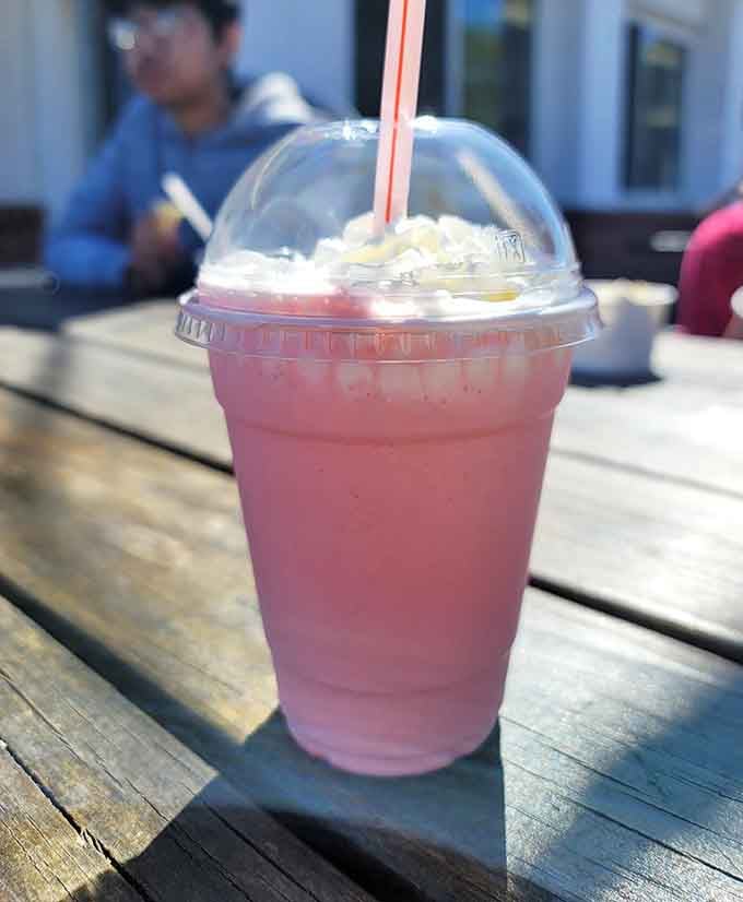 A strawberry milkshake topped with whipped cream, because some pleasures in life are worth the brain freeze risk.