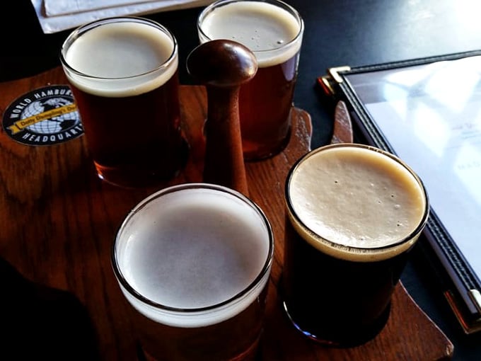 Four craft beers on a wooden paddle &ndash; because sometimes friendship means sharing everything, including your buzz.