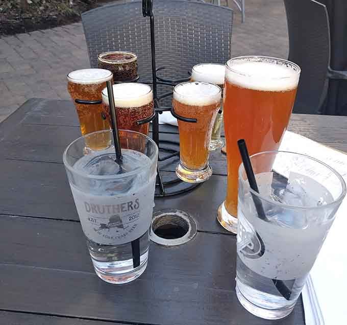 Beer flight on the patio because responsible adults sample multiple options before committing to a full pour.