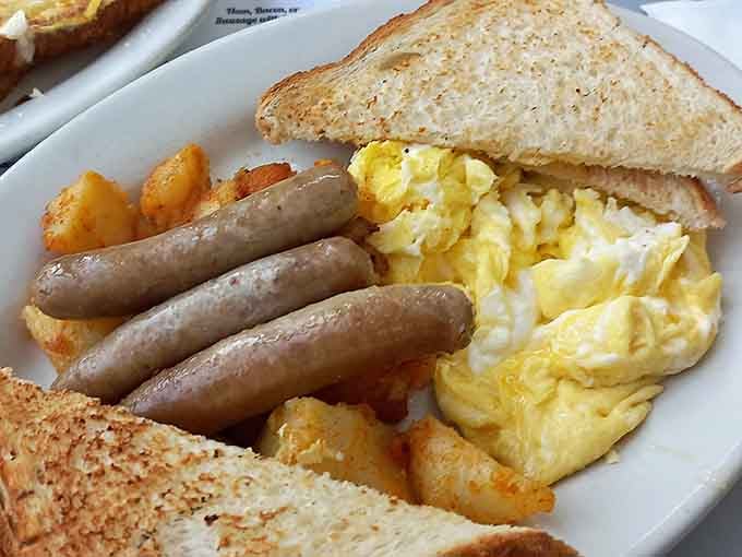 A hearty breakfast plate with eggs, sausage, and toast that fuels you properly for the day ahead.